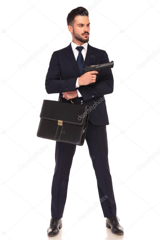 Young modern hitman showing his gun — Stock Photo © feedough #165197312