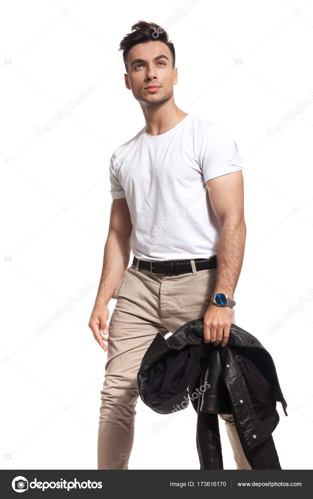 Young casual man holding jacket looks up Stock Photo by ©feedough 173616170