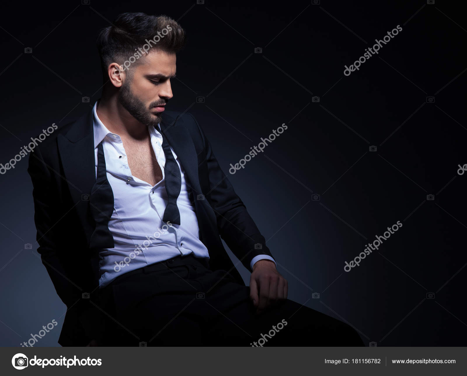 Sad elegant young man in tuxedo resting on a chiar Stock Photo by ...
