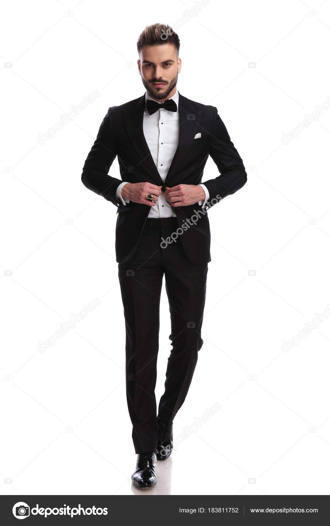 Smiling elegant man in tuxedo buttoning coat while walking — Stock ...