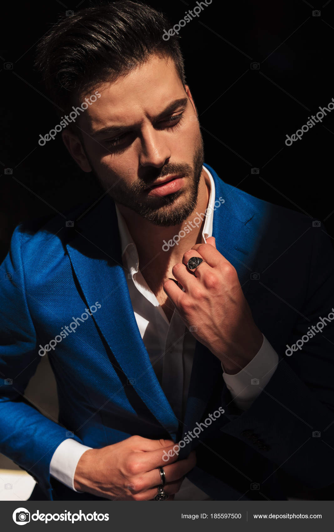Dramatic sexy man holding collar and looks to side Stock Photo by ...
