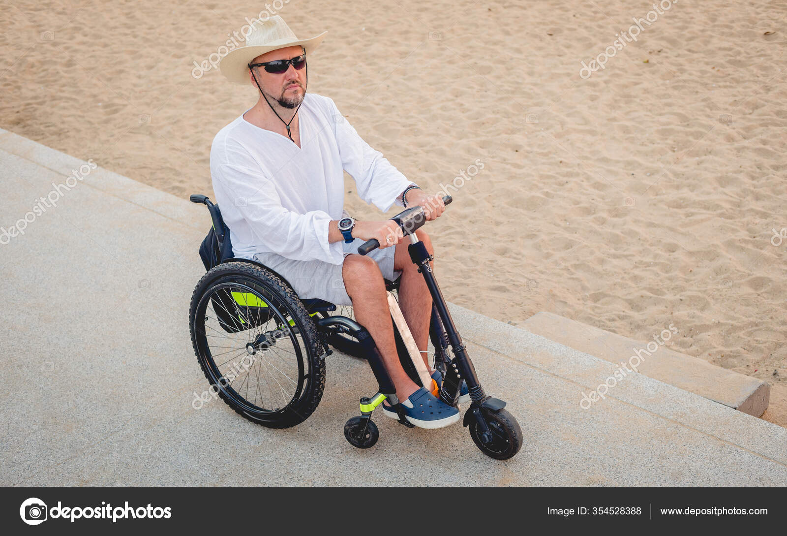 Disabled man in a wheelchair with electric scooter on the beach — Stock ...