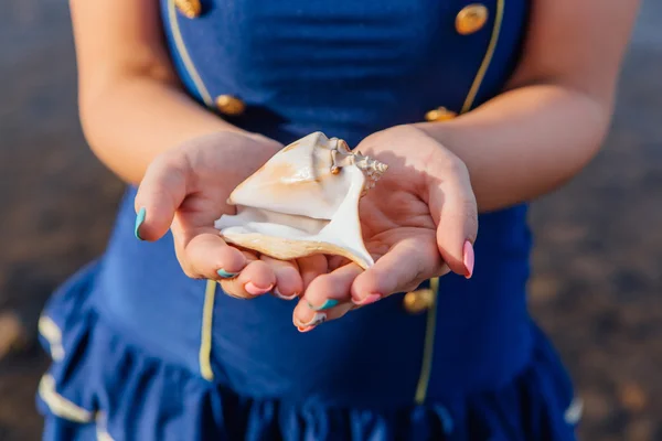 Woman holding shells in hands Stock Photo by ©Smile19 127376958