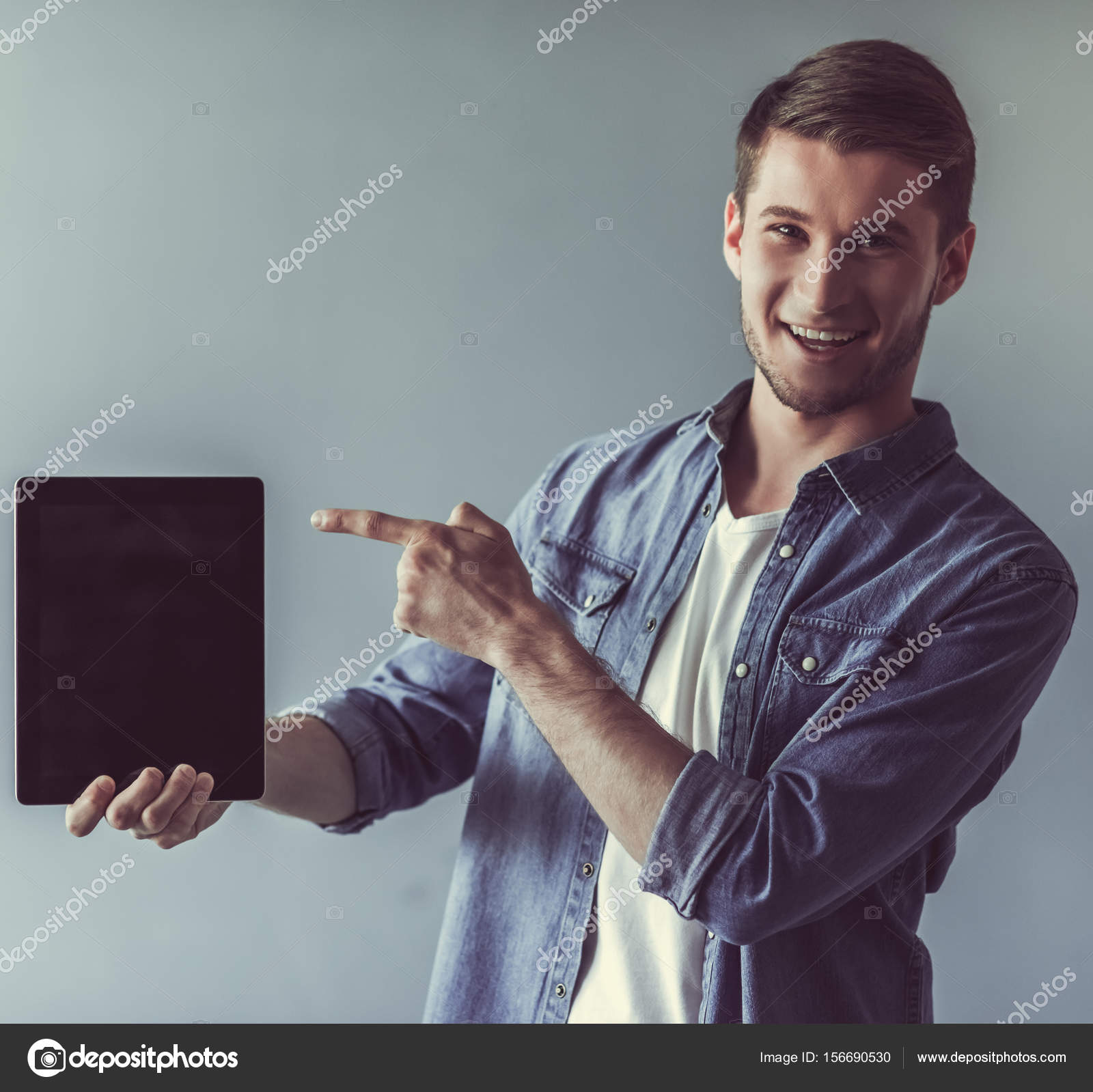 Handsome guy with gadget Stock Photo by ©GeorgeRudy 156690530