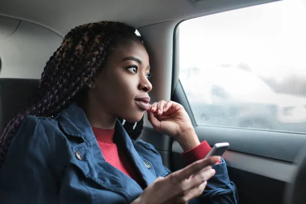 Woman thinking in car - Stock Image - Everypixel
