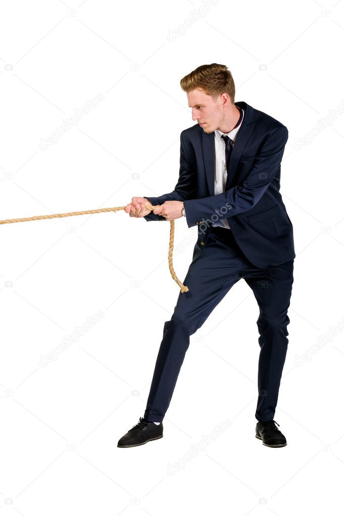 Young businessman pulling a rope Stock Photo by ©toxawww 125835164