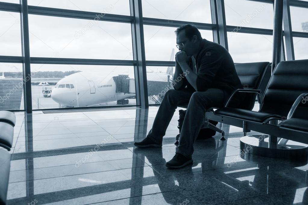 Sad man waiting for delayed flight — Stock Photo © toxawww #126604672