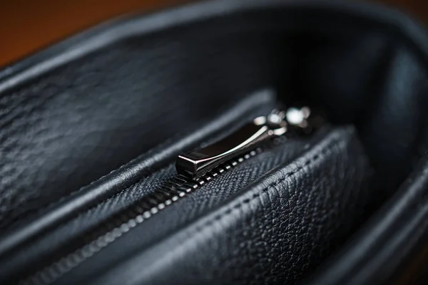 Details and elements of the bag are handmade from black leather, close ...