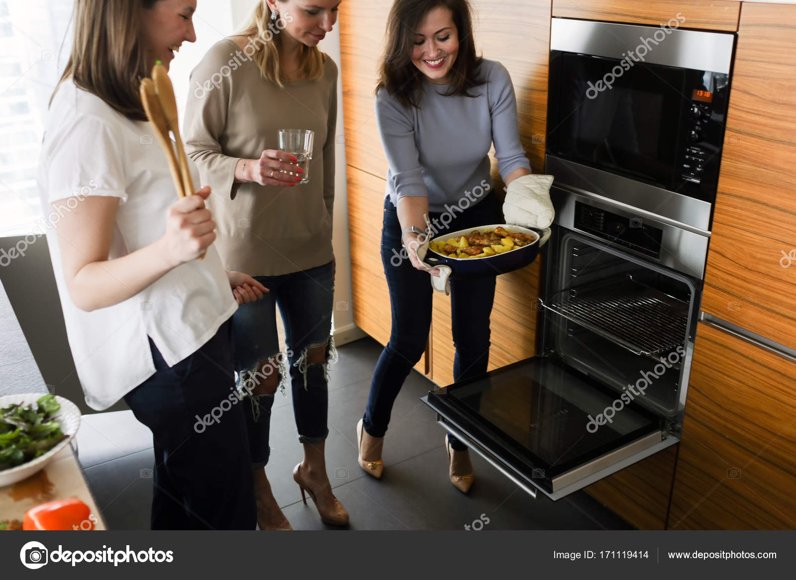 Young women having dinner together Stock Photo by ©Dmitry.Zimin 171119414
