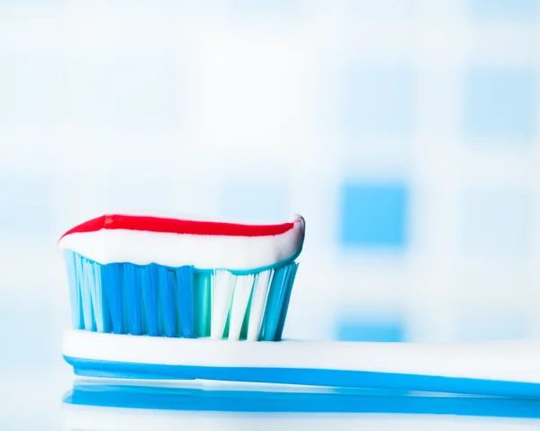 Toothbrush with red stripe toothpaste Stock Photo by ©nikkytok 123658464