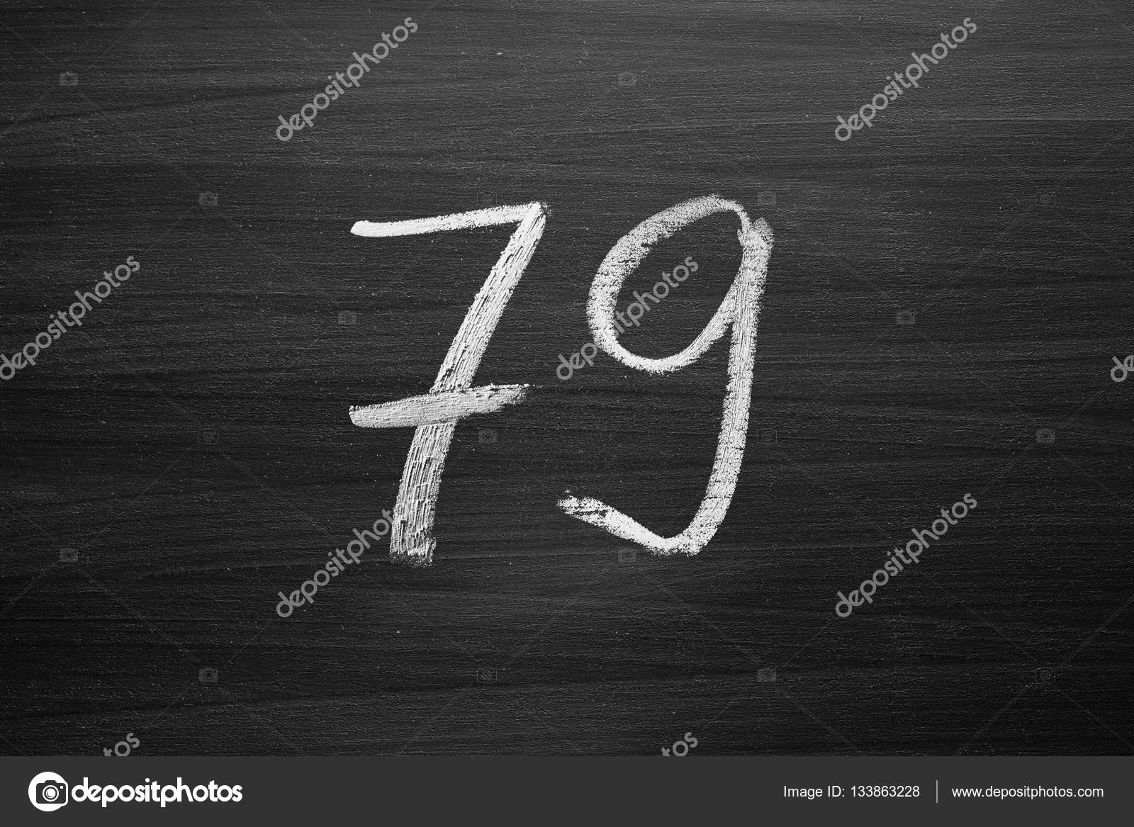 Number seventy nine enumeration written with a chalk on the blackboard ...