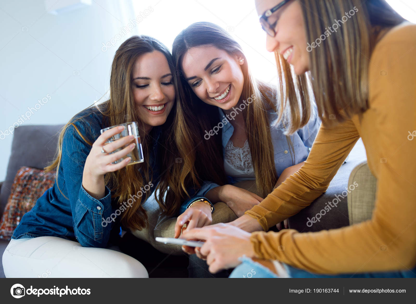 Three happy beautiful women using smartphone at home. — Stock Photo ... Three happy beautiful women using smartphone at home. — Stock Photo ...