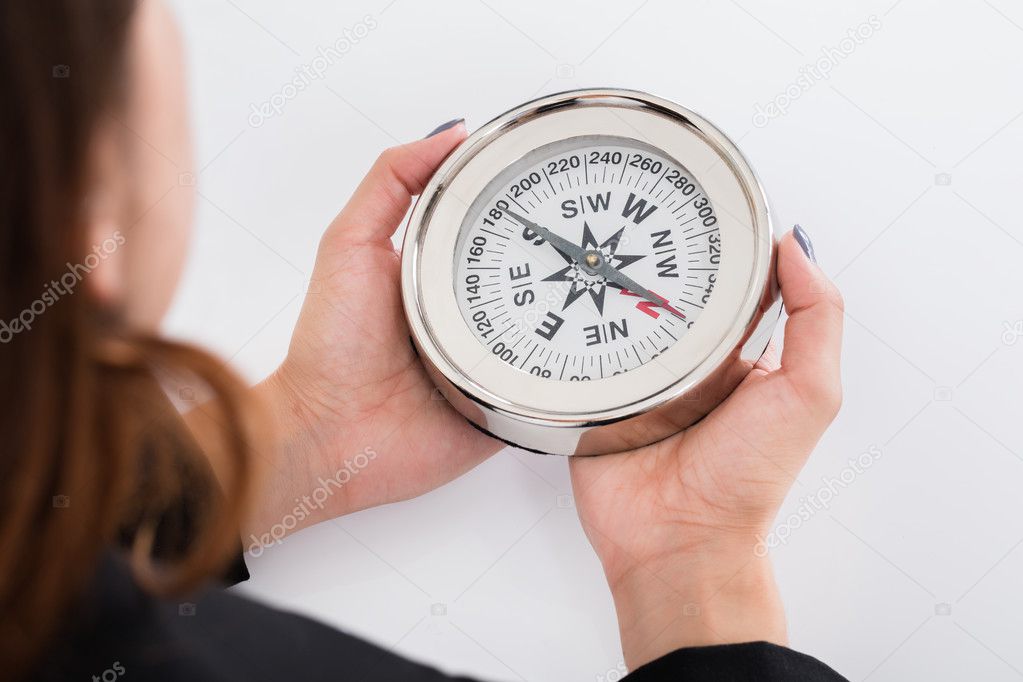 Businesswoman Hand Holding Compass — Stock Photo © AndreyPopov #128493934