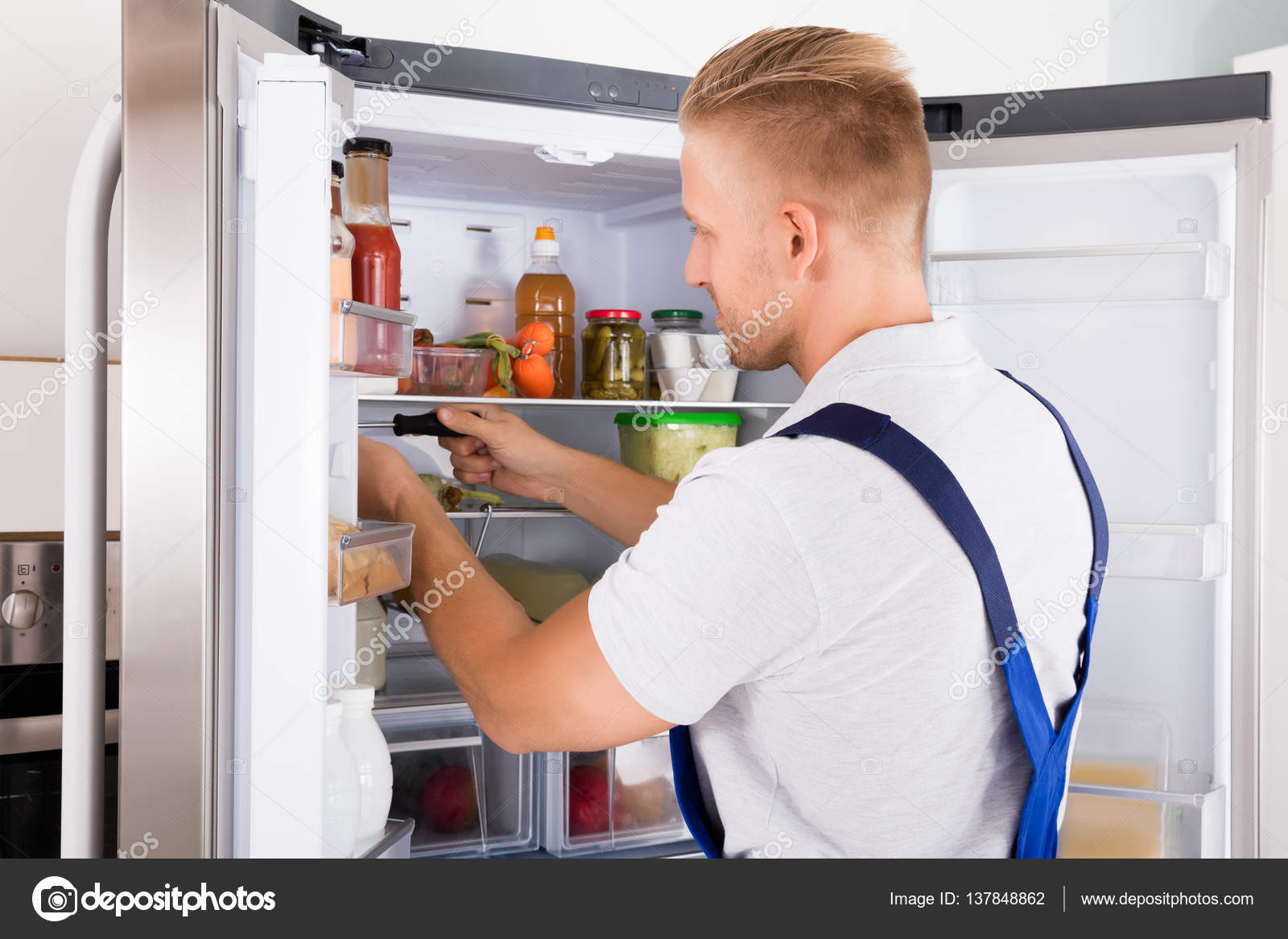Repairman Checking Refrigerator — Stock Photo © AndreyPopov #137848862