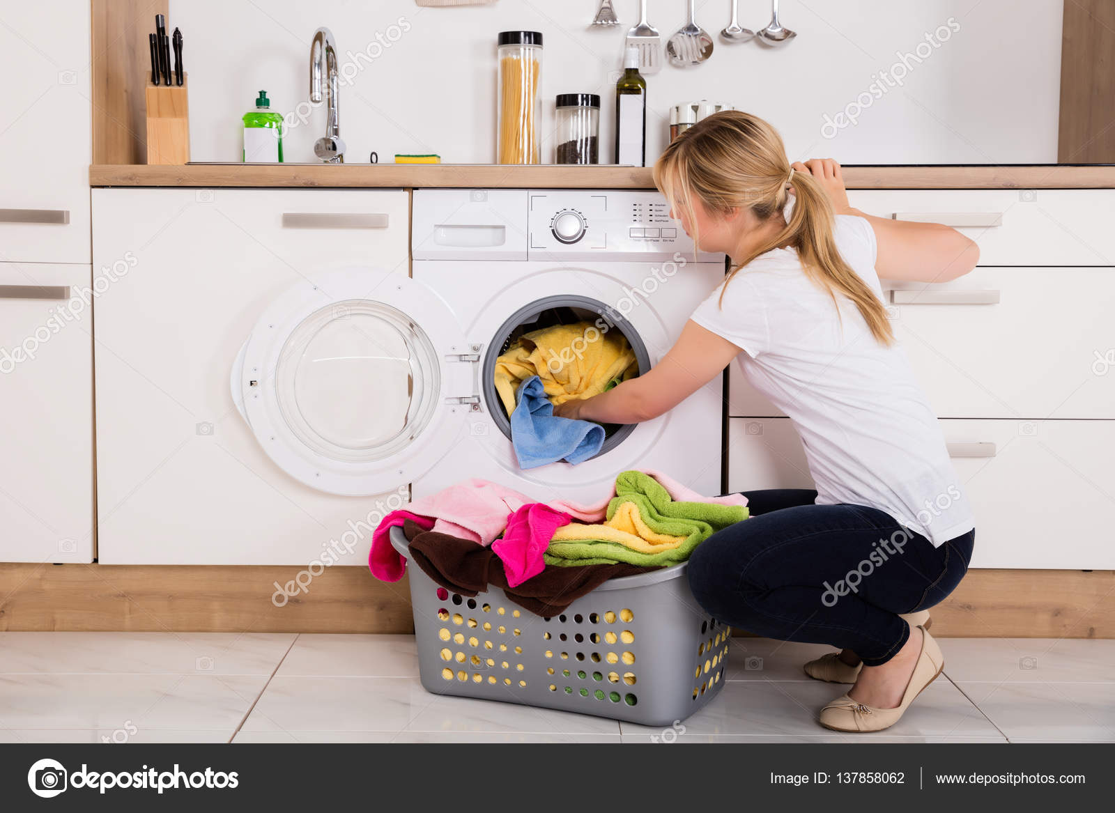 Woman Loading Clothes Stock Photo by ©AndreyPopov 137858062