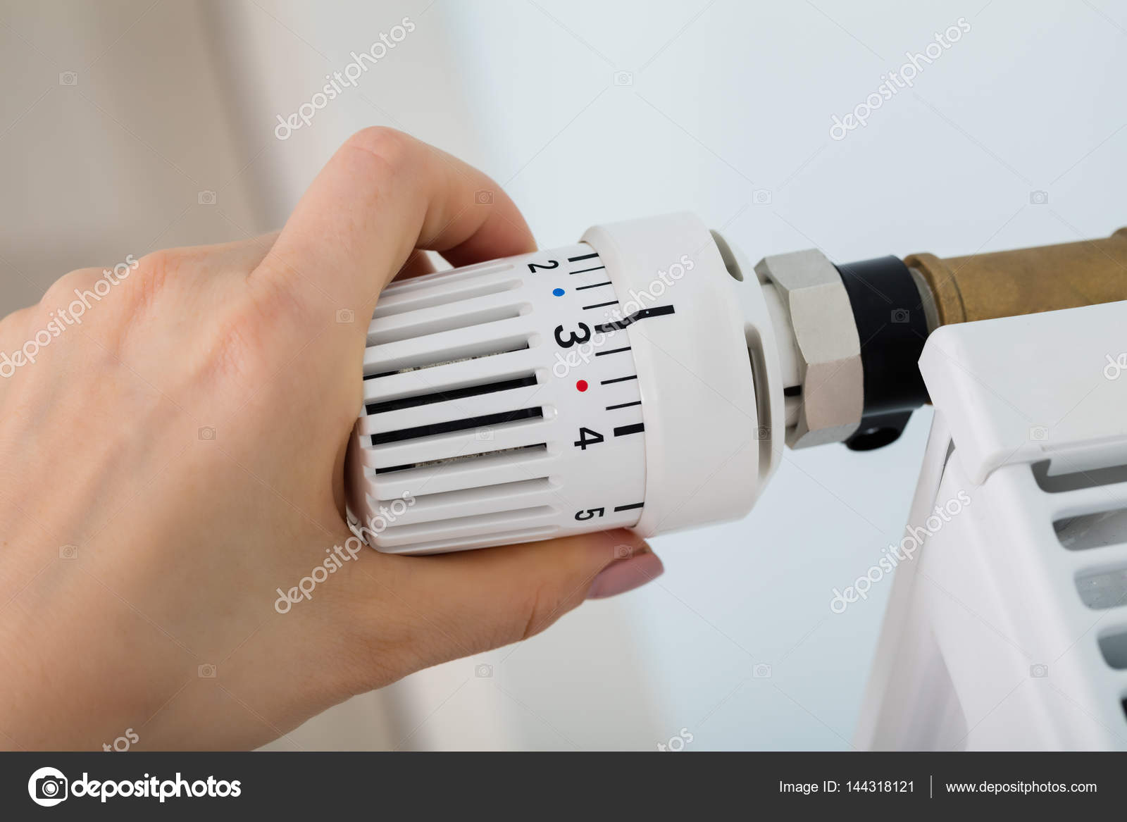 Hand Adjusting Thermostat Valve — Stock Photo © AndreyPopov #144318121