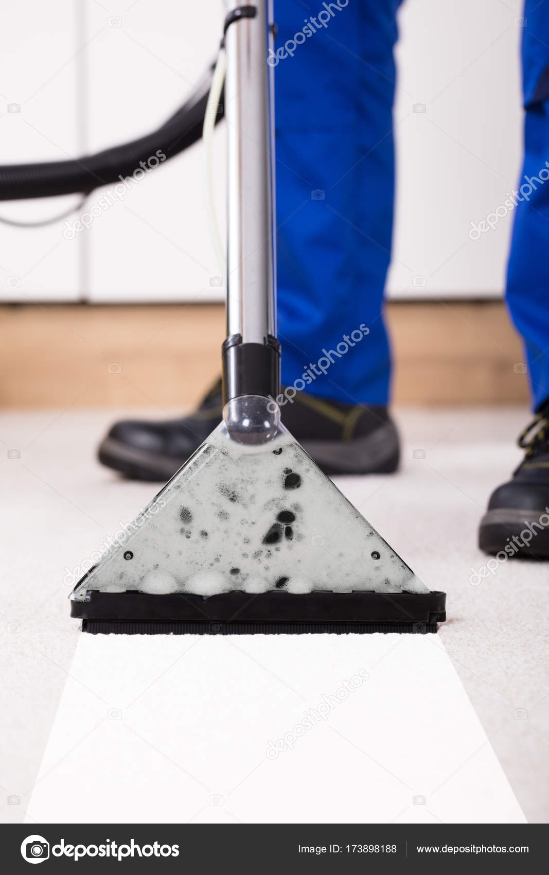 Person Using Vacuum Cleaner — Stock Photo © AndreyPopov #173898188