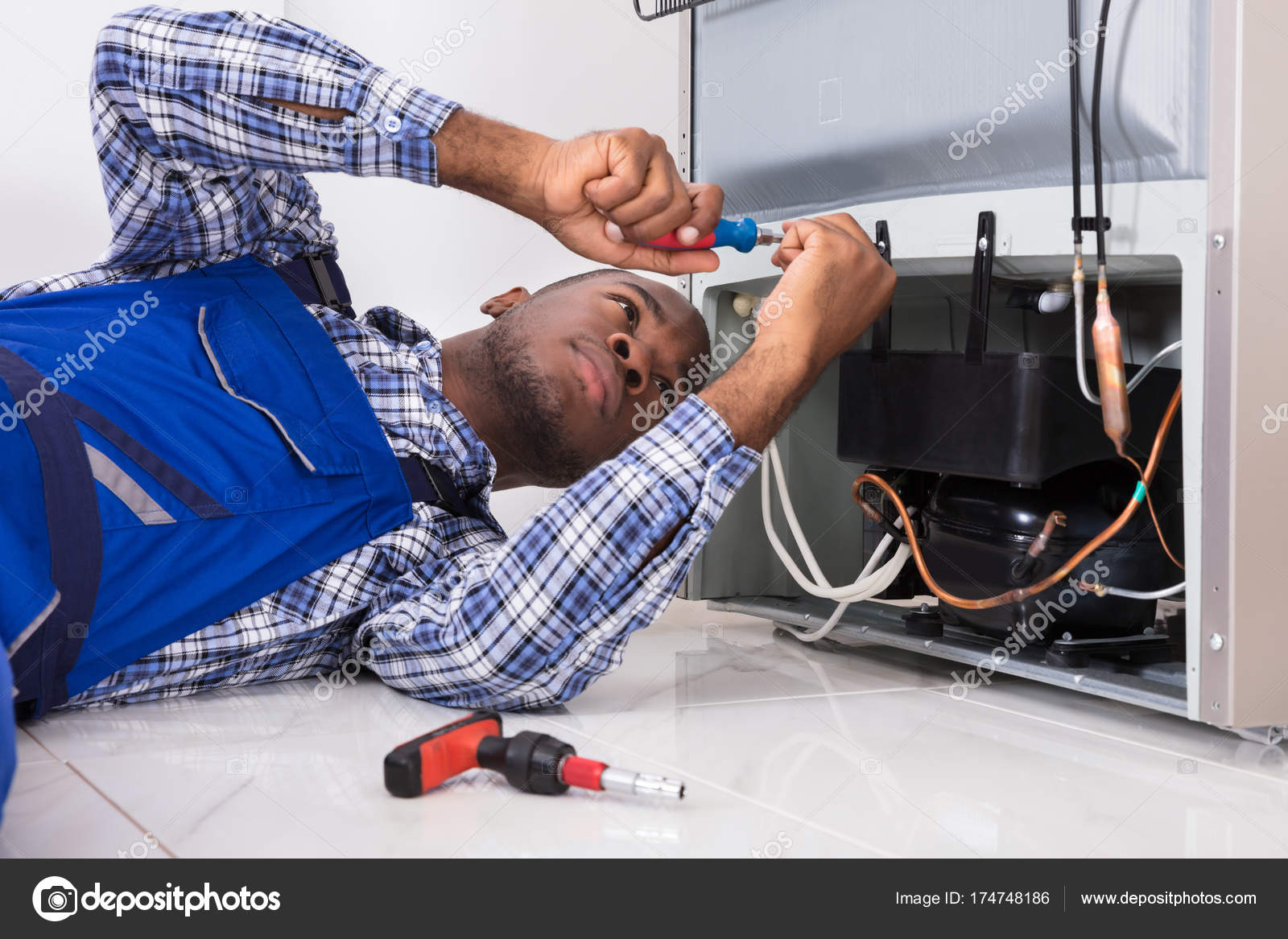 Serviceman Working On Fridge — Stock Photo © AndreyPopov #174748186