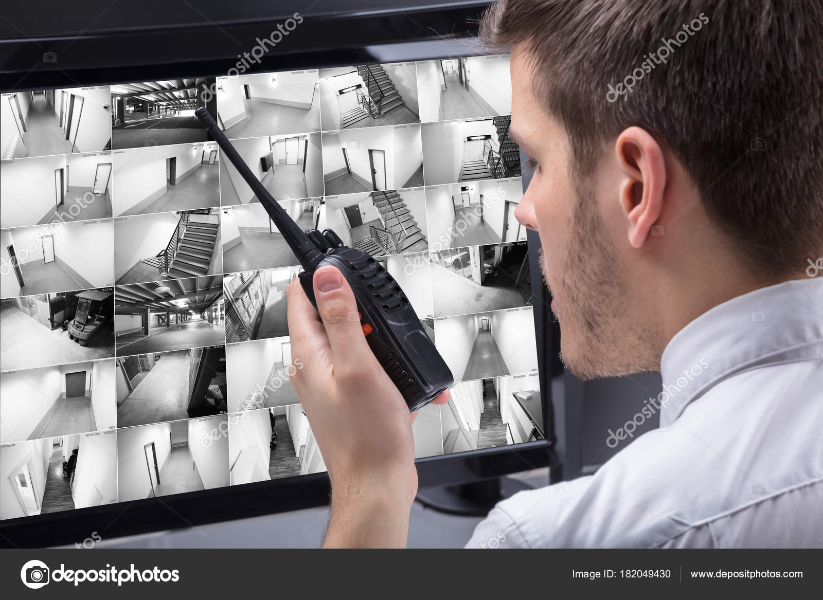 Young Male Security Guard Talking Walkie Talkie While Monitoring ...