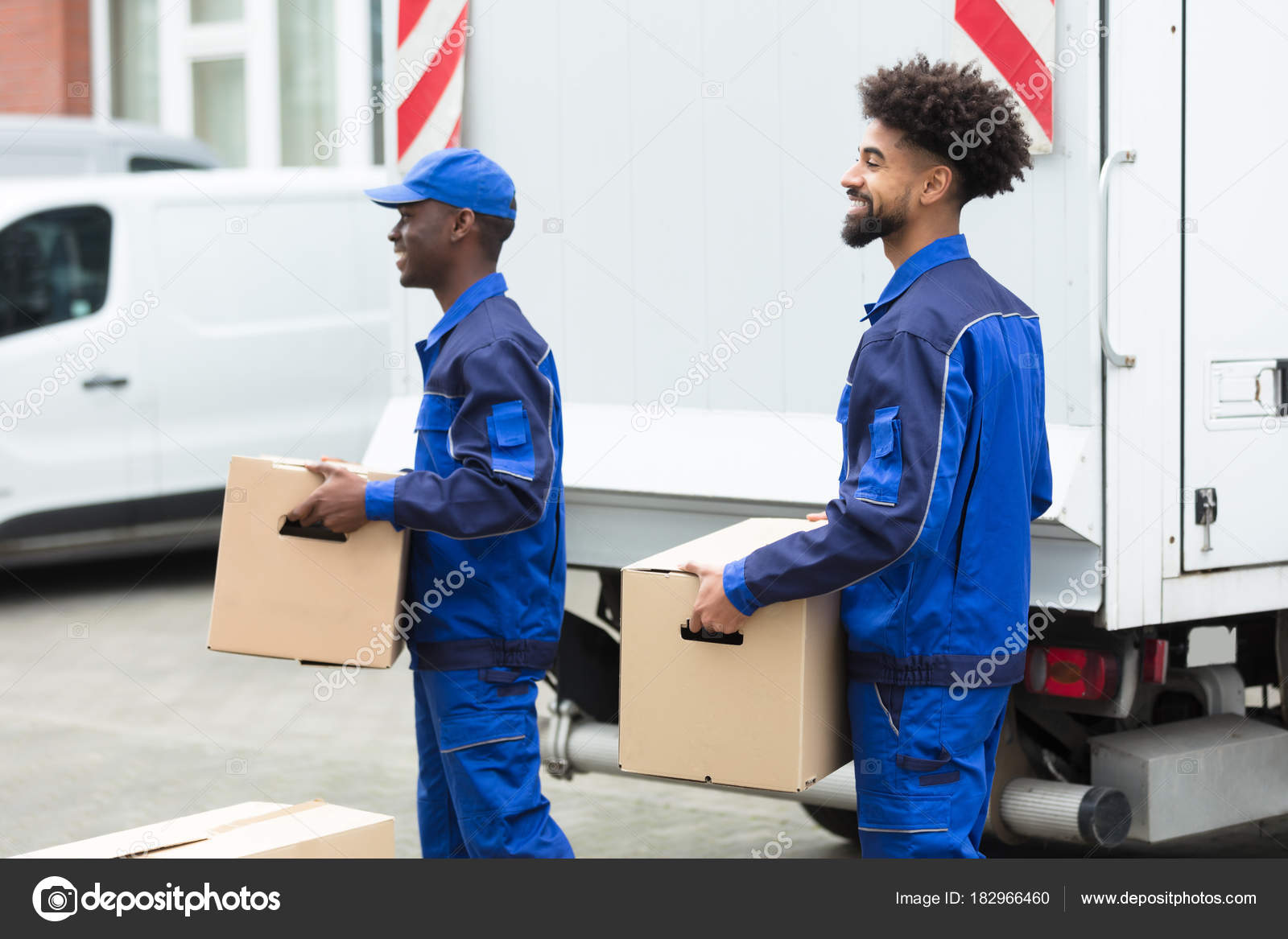 Close Two Delivery Men Holding Cardboard Boxes Stock Photo by ...