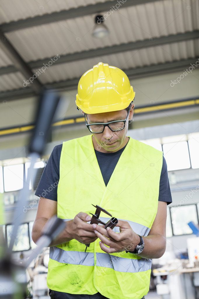 Worker measuring metal with caliper in industry — Stock Photo ...