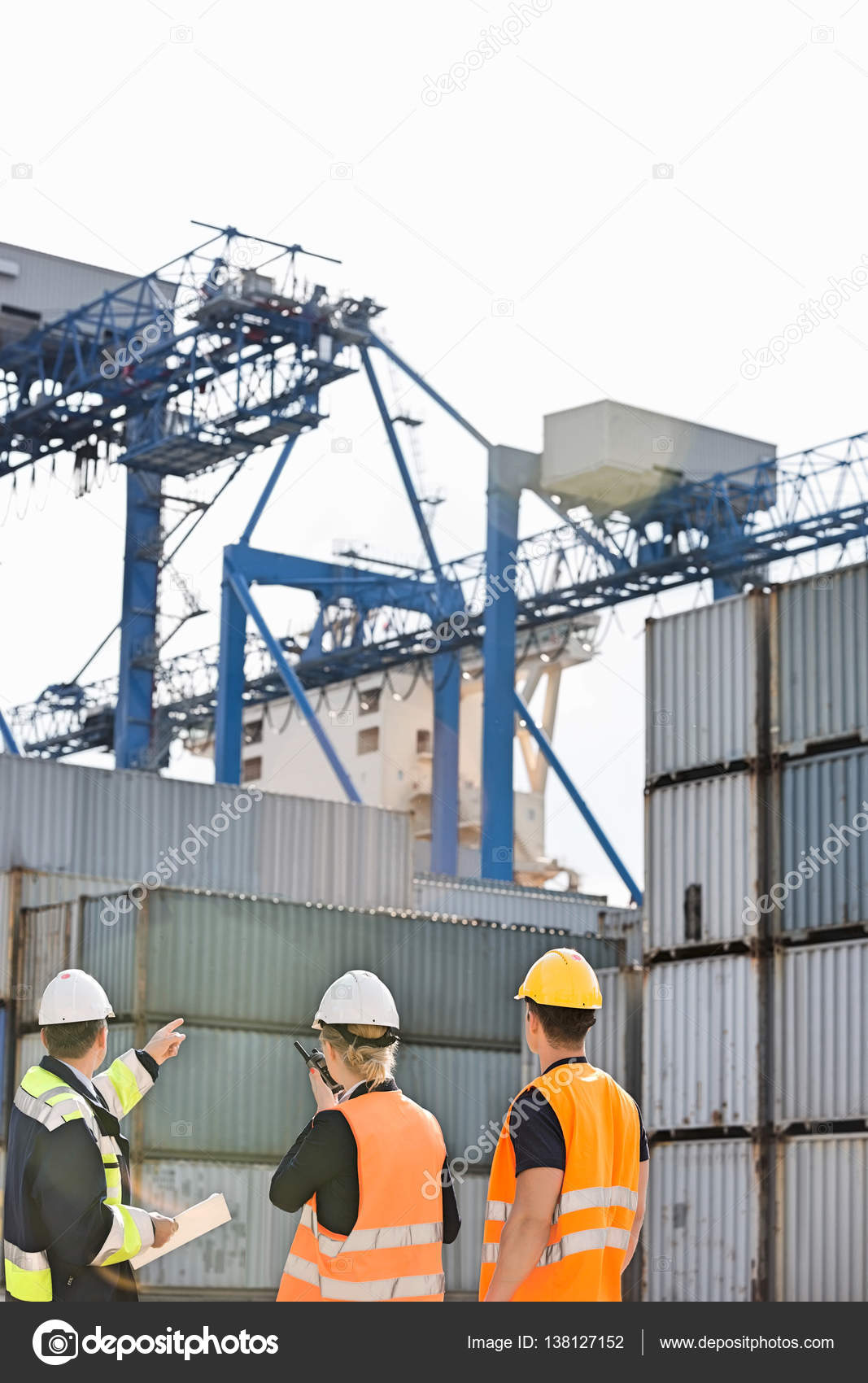 Workers inspecting cargo containers Stock Photo by ©londondeposit 138127152