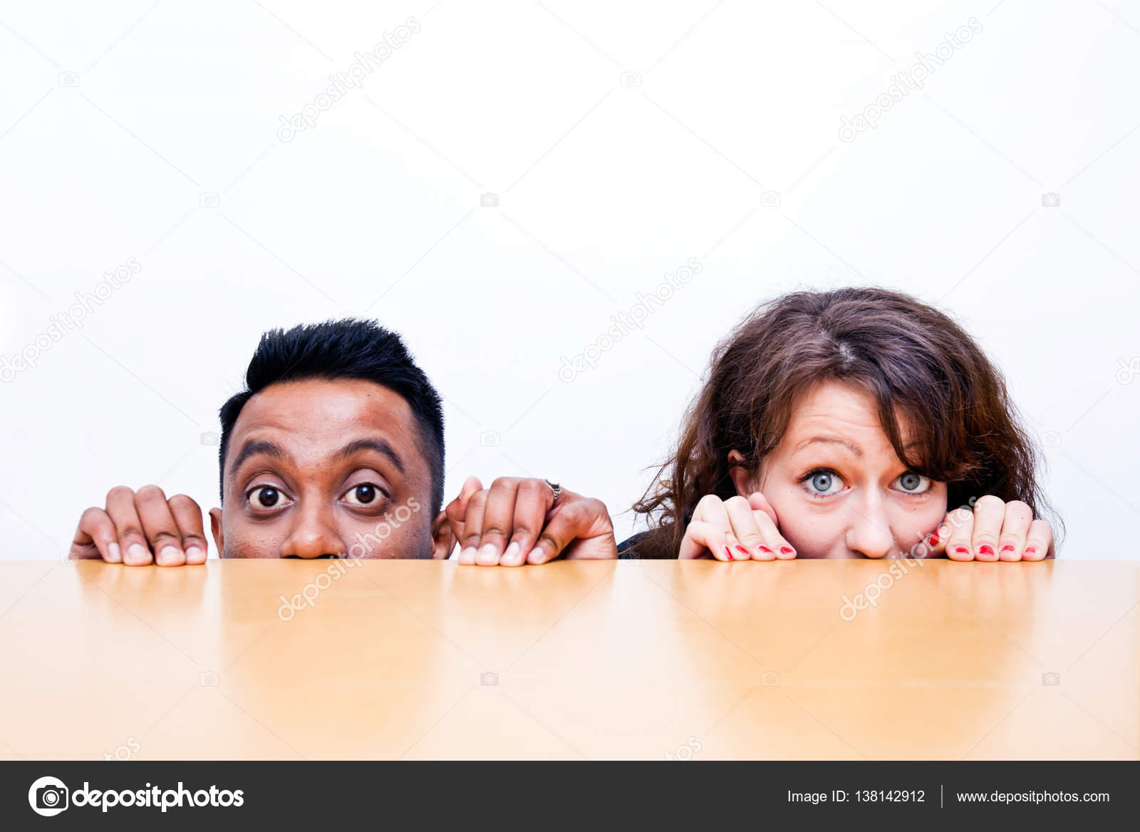 Colleagues peeking over table — Stock Photo © londondeposit #138142912