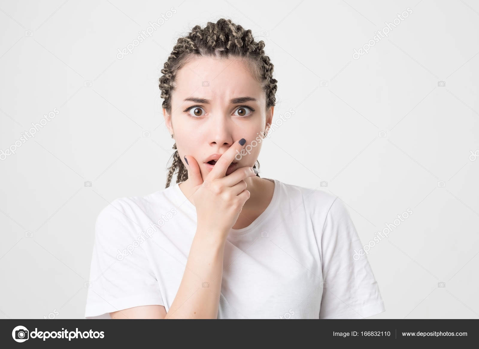 Confused young female posing isolated at white wall Stock Photo by ...