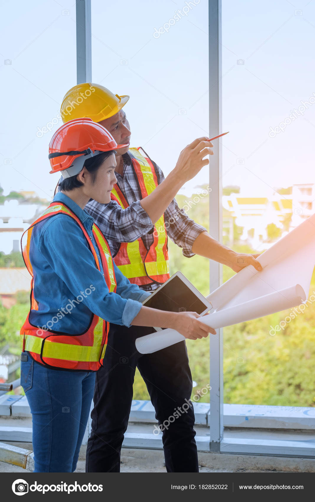 Engineers are meeting, working and looking at Home blueprint in Stock ...