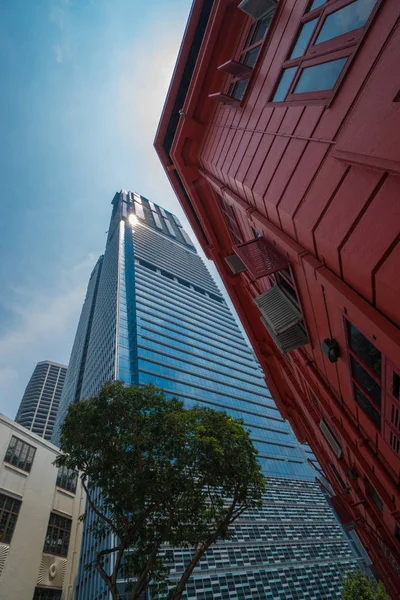 Vintage red building with wooden shutters and modern skysraper - Stock ...