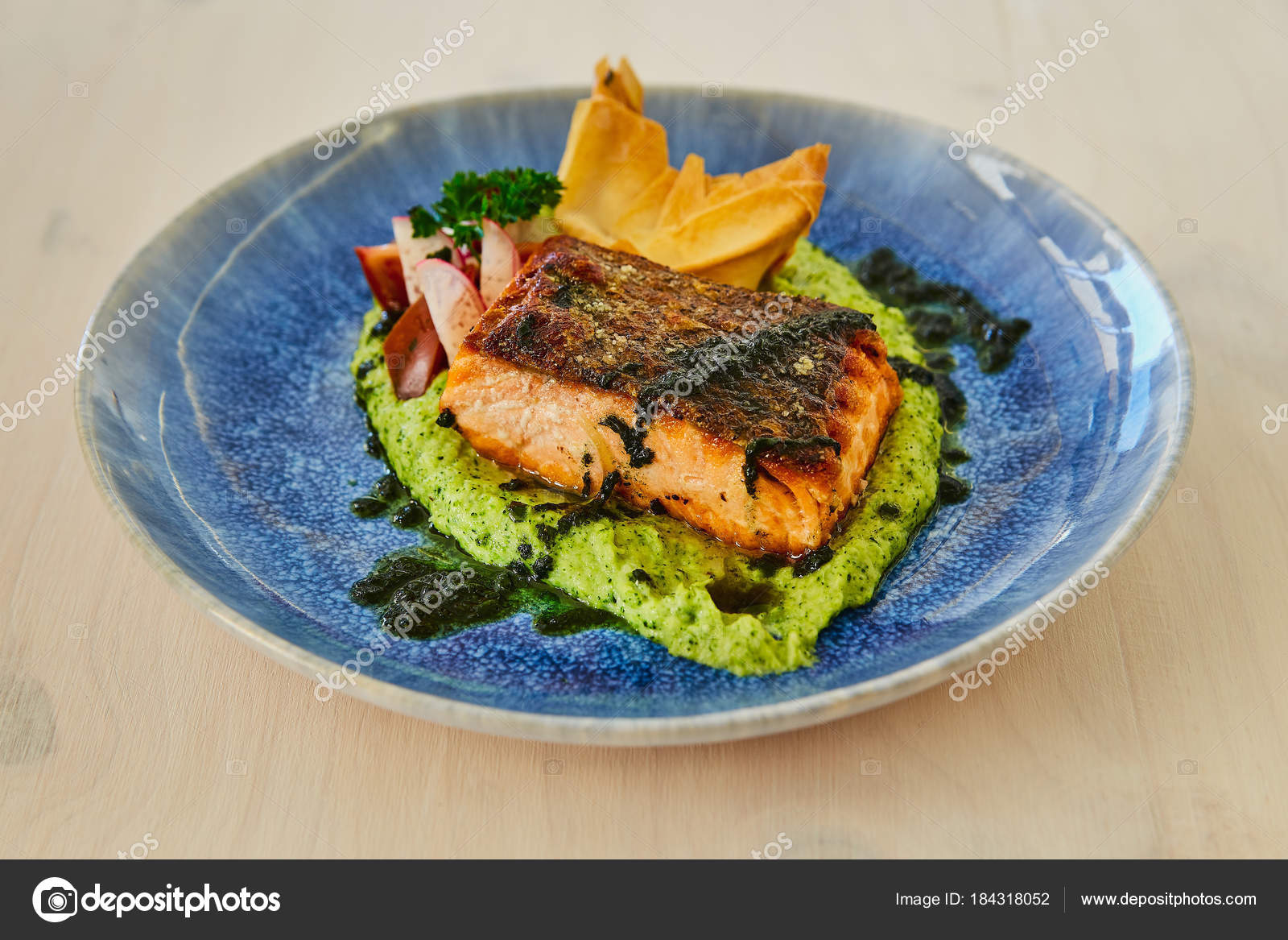Large juicy roasted fatty piece of salmon steak on a cushion of ...