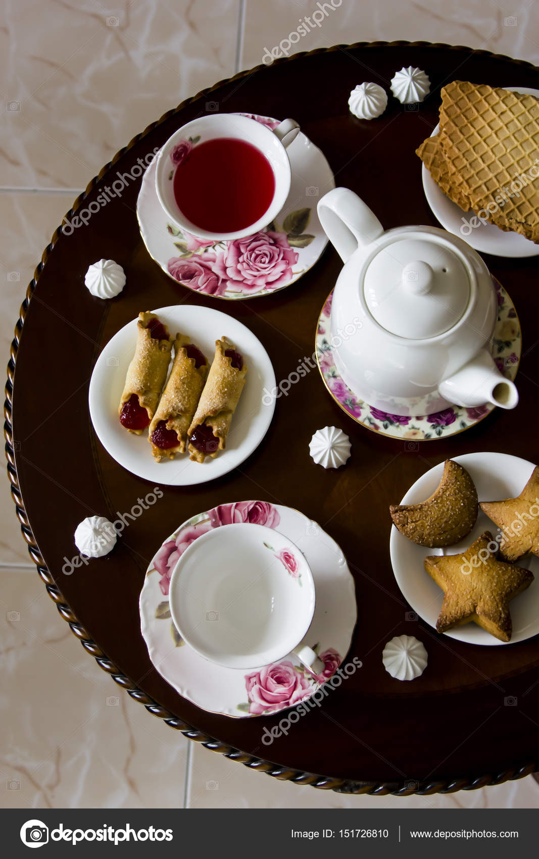 Karkade with sweets. Traditional family tea for three at a round table ...