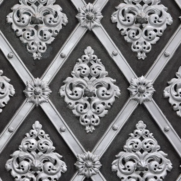 Ancient forged metal texture with decorative overlays. Doors, gates ...