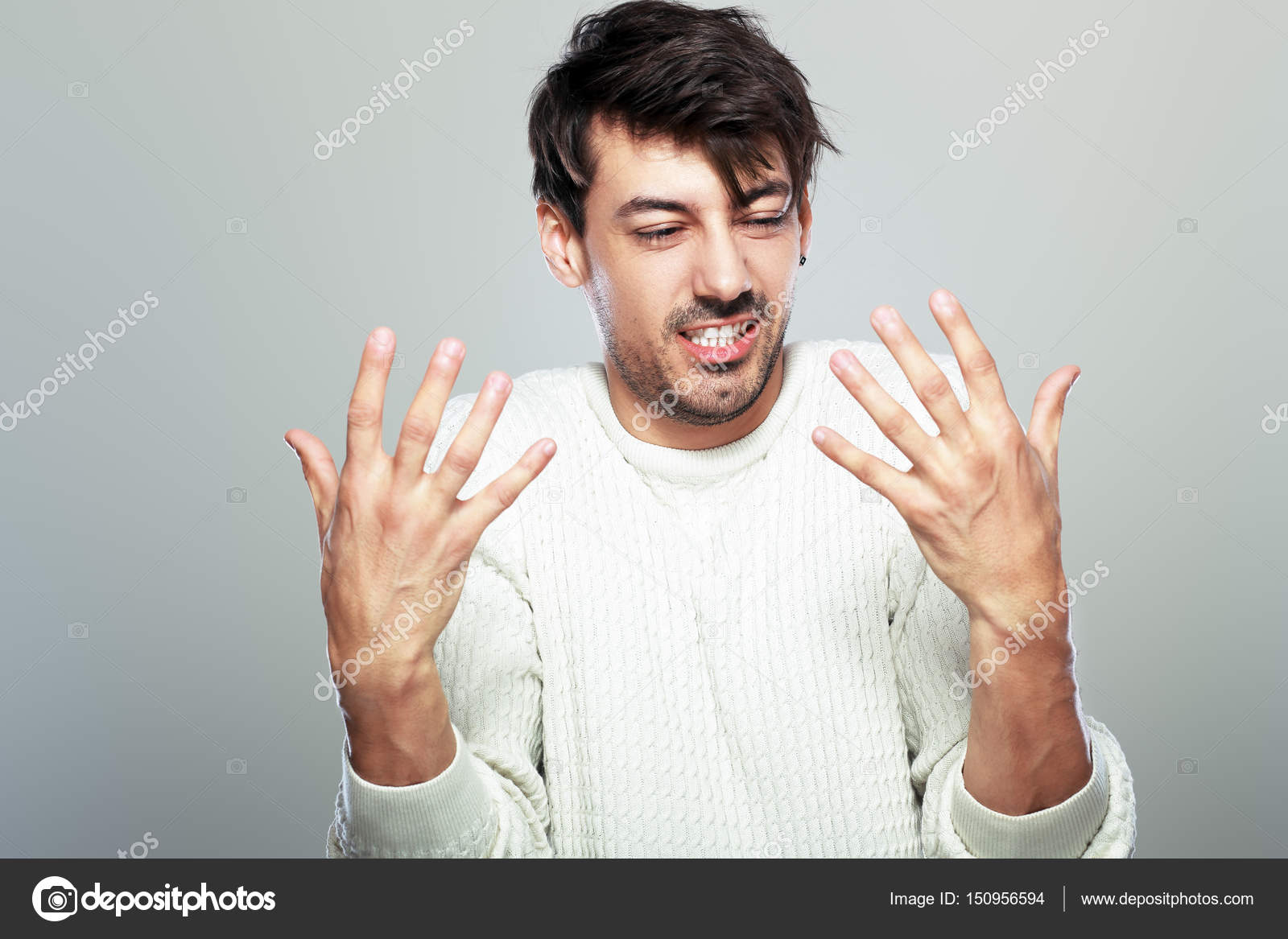 Young man looking on his hands Stock Photo by ©lenanet 150956594