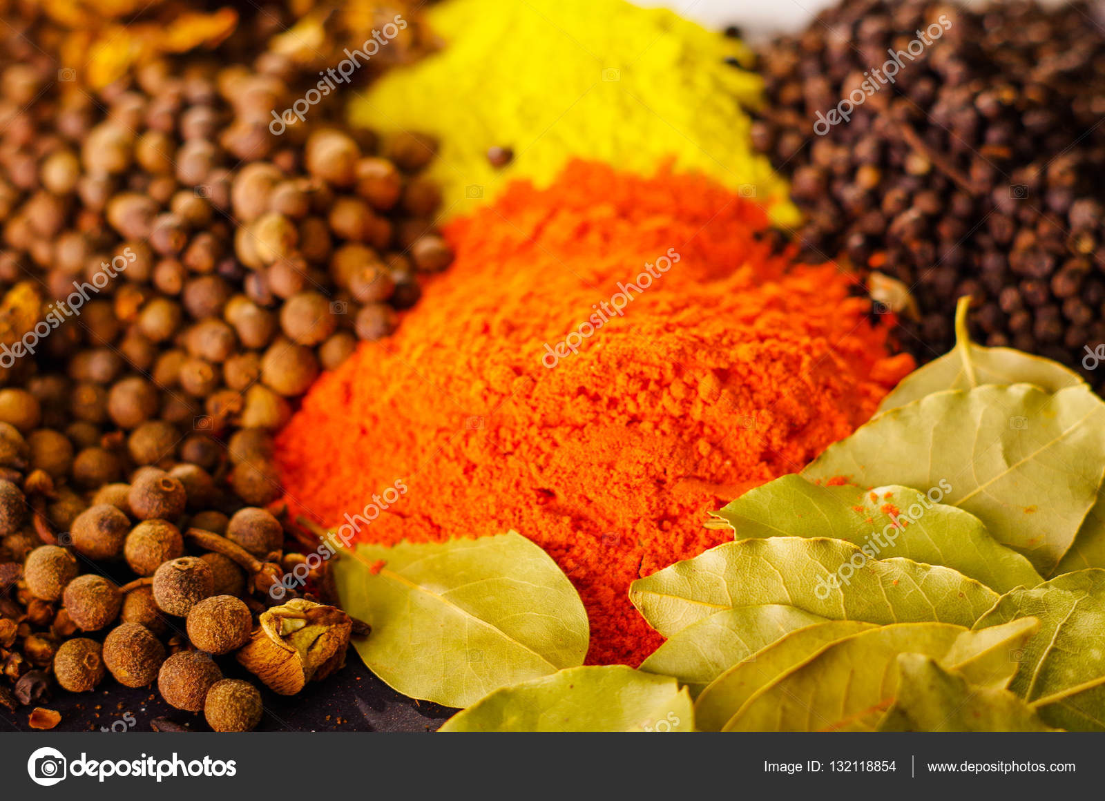 Closeup from above different piles of colorful spices, beautiful rustic setting, spice and ...