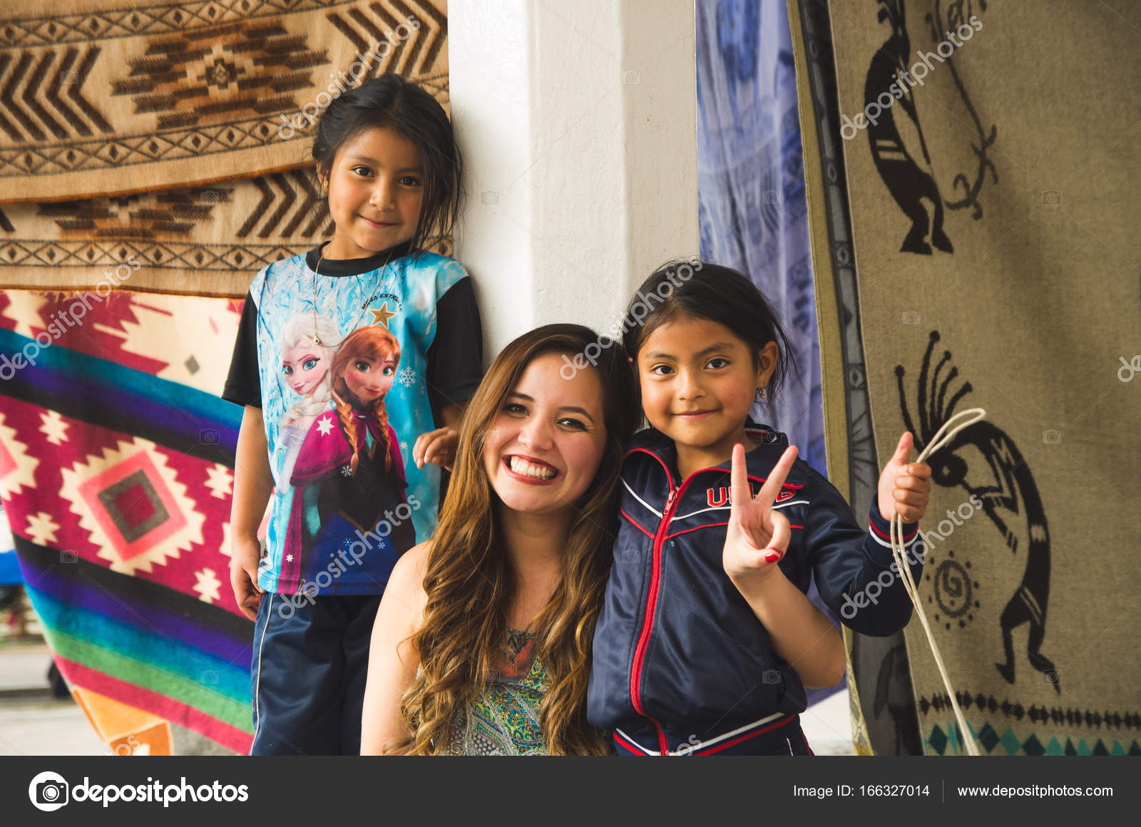 OTAVALO, ECUADOR - MAY 17, 2017: Beautiful young woman hugging to two ...