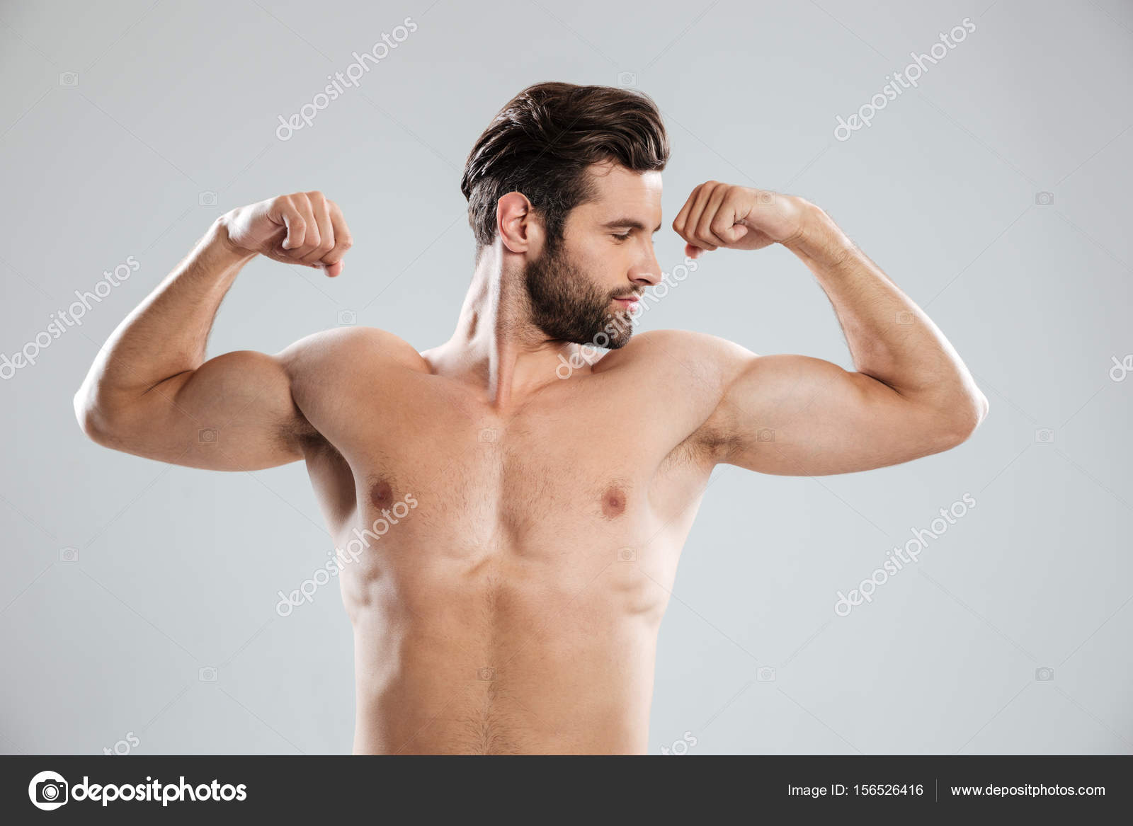 Confident man showing his biceps and looking at camera — Stock Photo ...