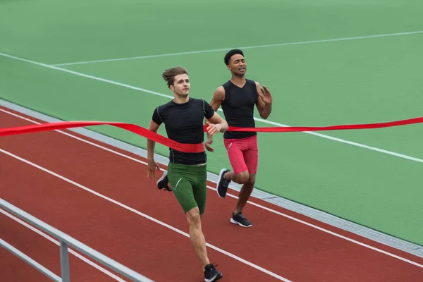 Happy young athlete man run on running track - Stock Image - Everypixel