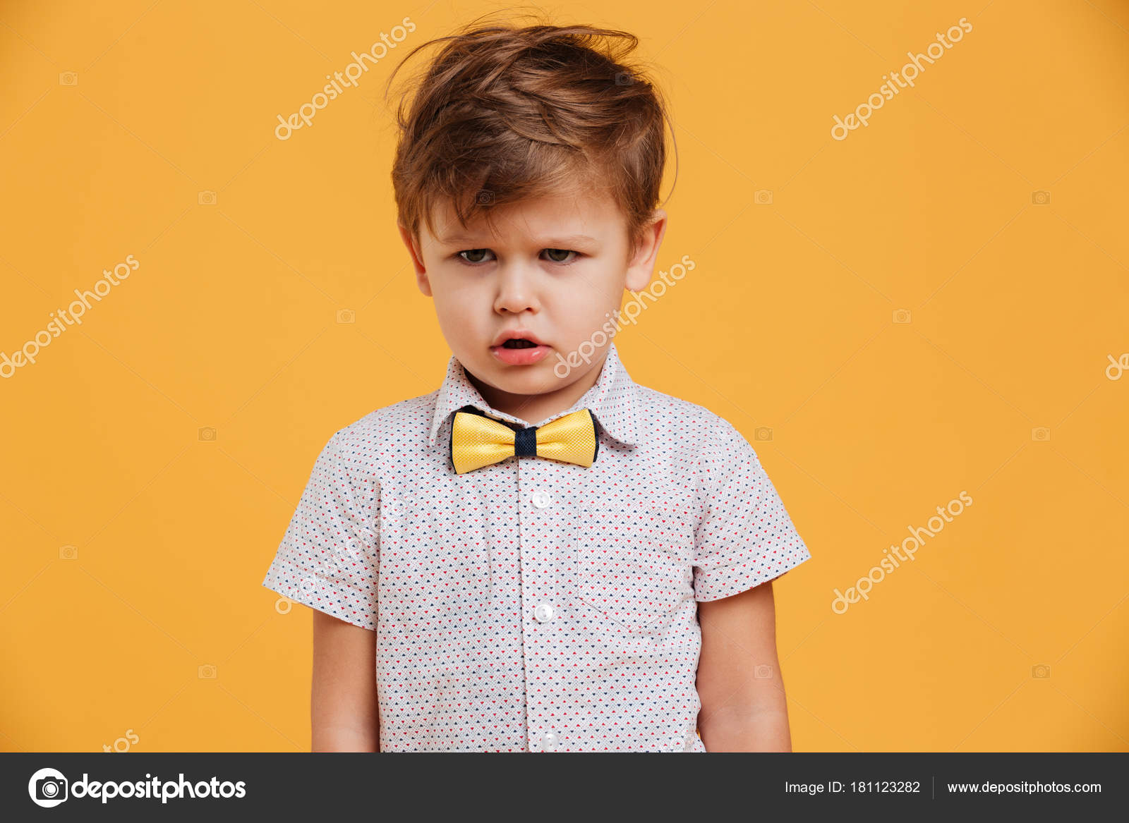 Sad little boy child standing isolated over yellow Stock Photo by ...