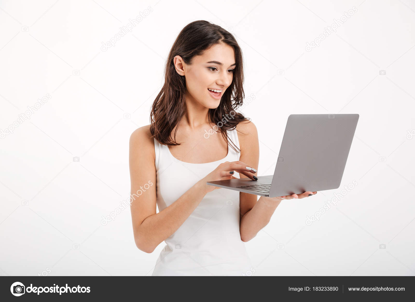 Portrait of a pretty girl dressed in tank-top using laptop Stock Photo ...