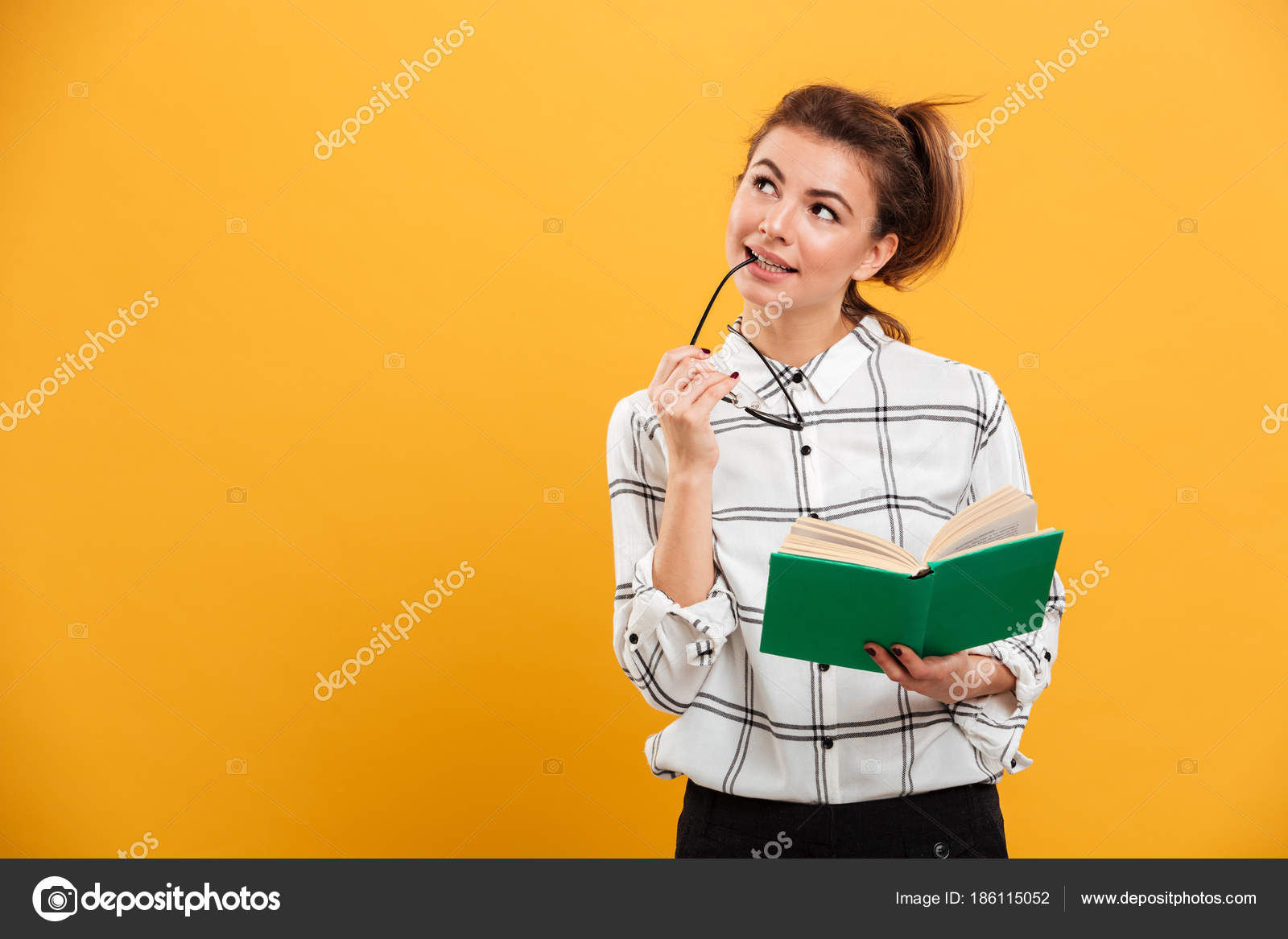 Photo of young brooding woman looking aside while holding book a ...