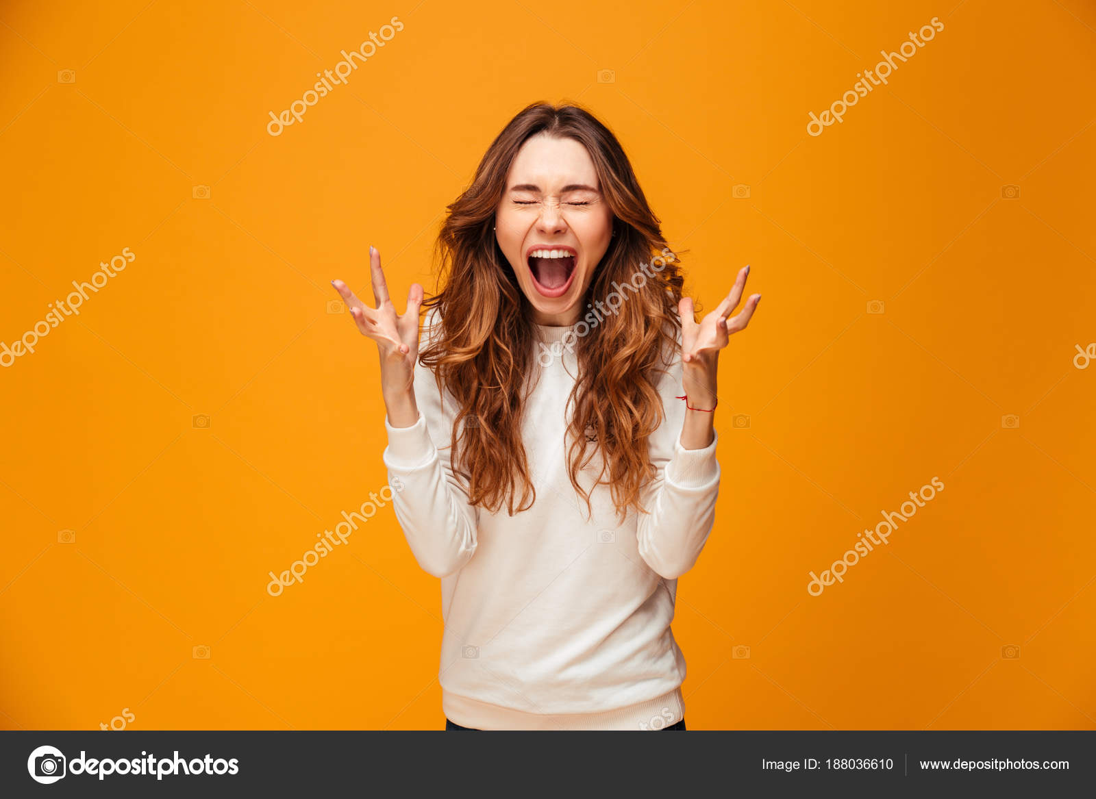 Confused screaming brunette woman in sweater with closed eyes Stock ...