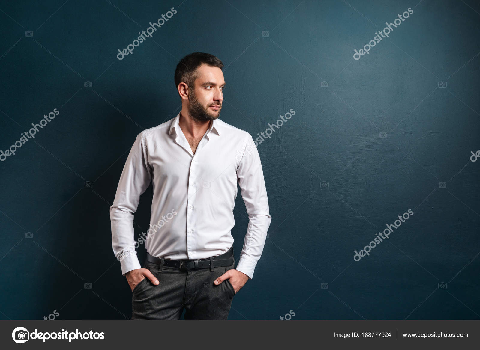 Handsome serious man standing over dark blue background — Stock Photo ...