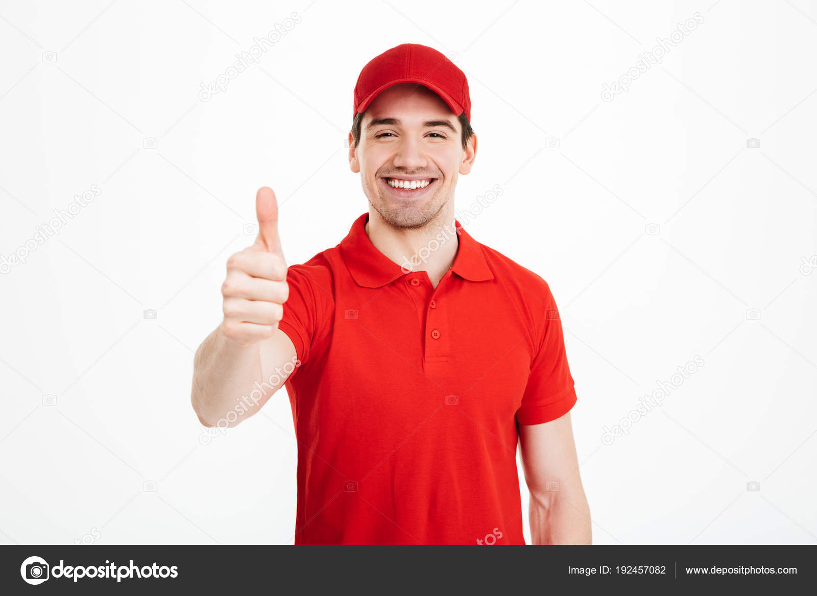 Cheerful young delivery man in red cap with thumbs up Stock Photo by ...