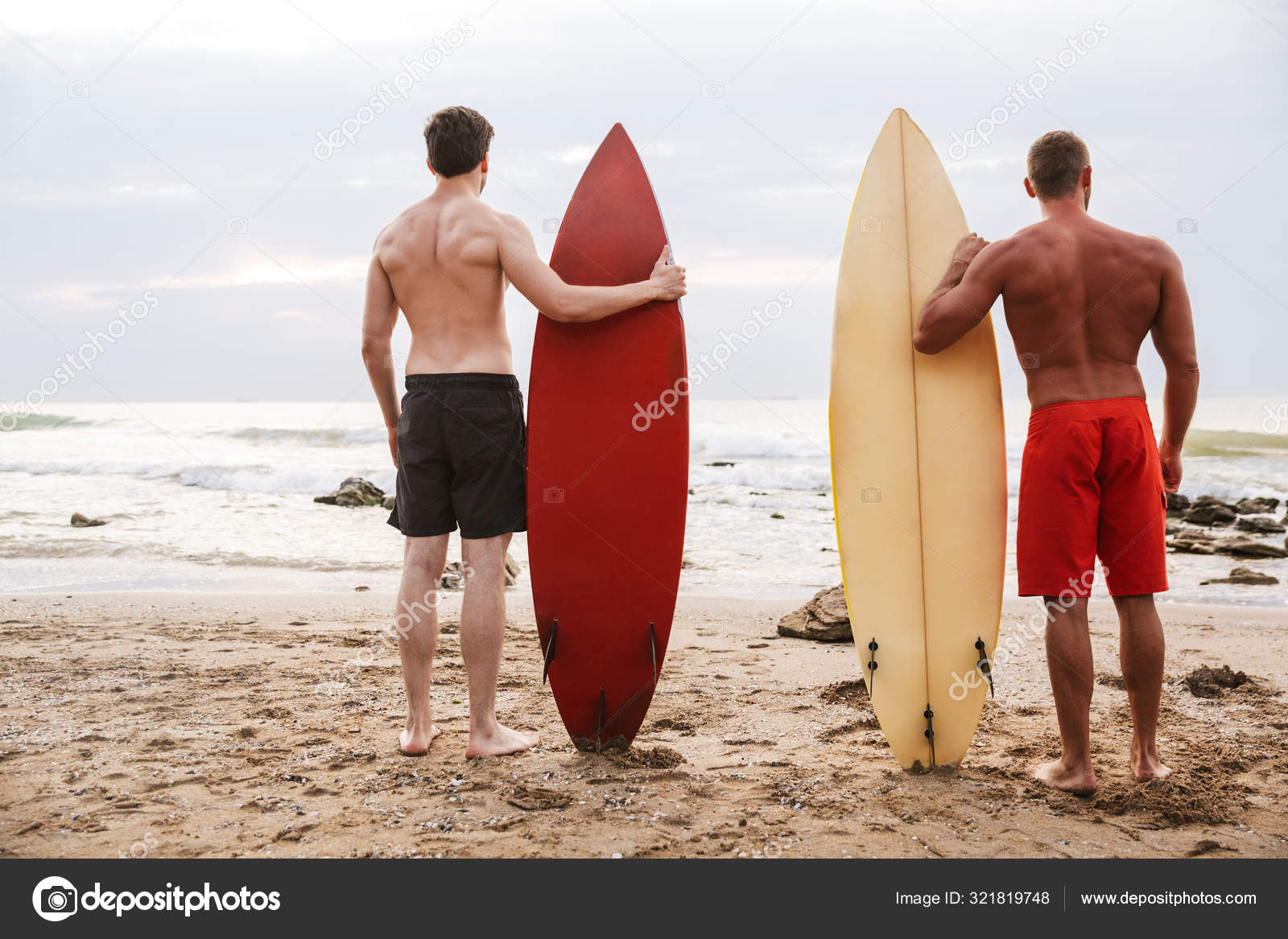 Two men surfers friends on a beach outside. Stock Photo by ...