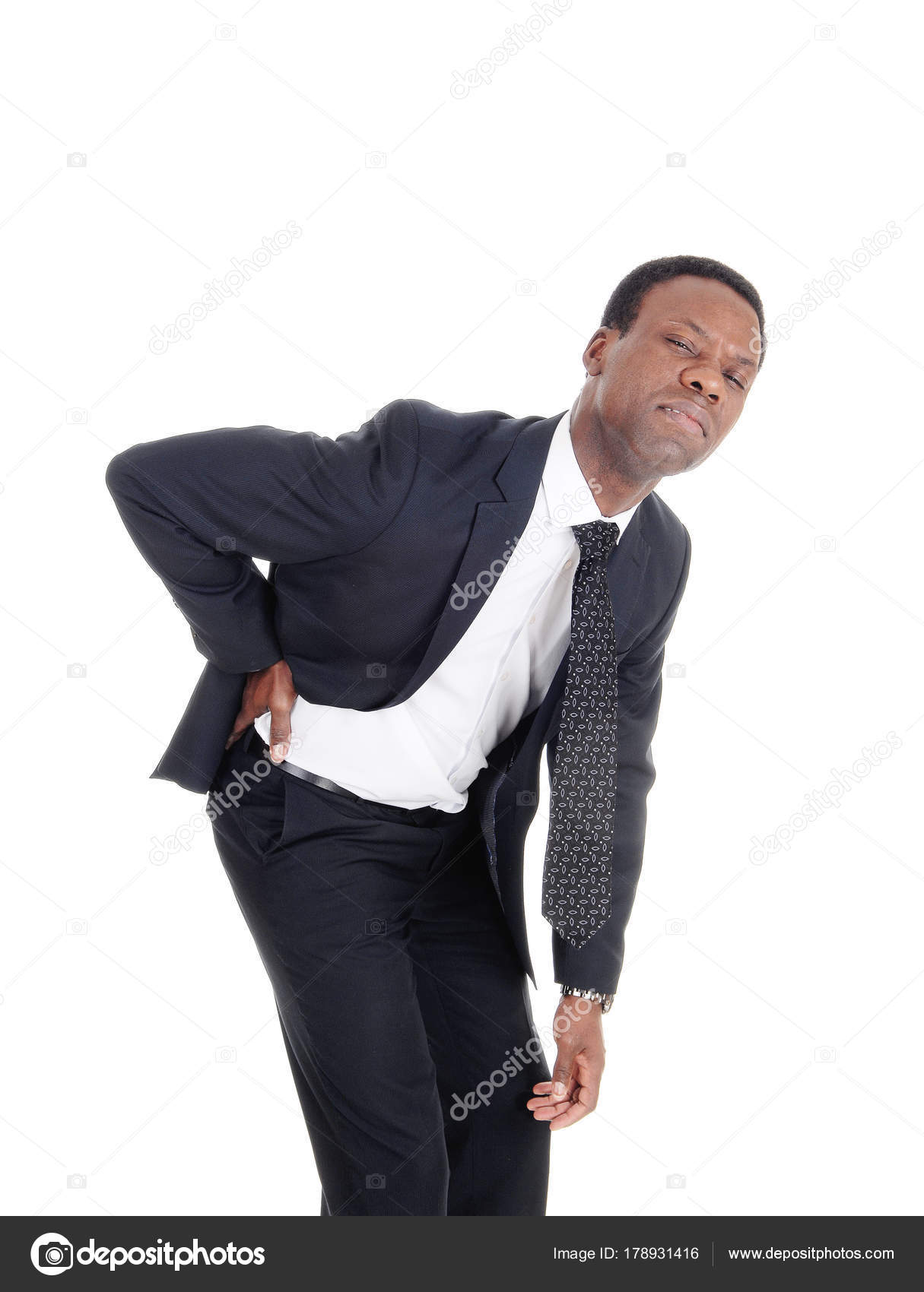 Man with back pain bending forward — Stock Photo © sucher #178931416