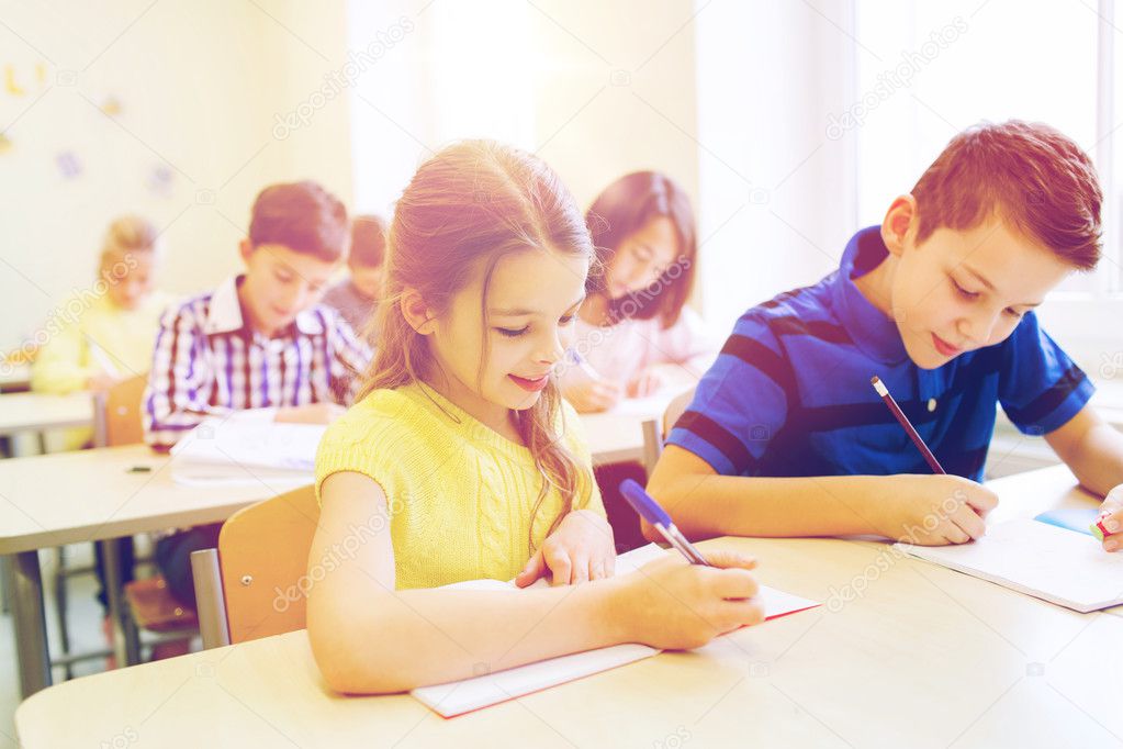 Group of school kids writing test in classroom — Stock Photo © Syda ...