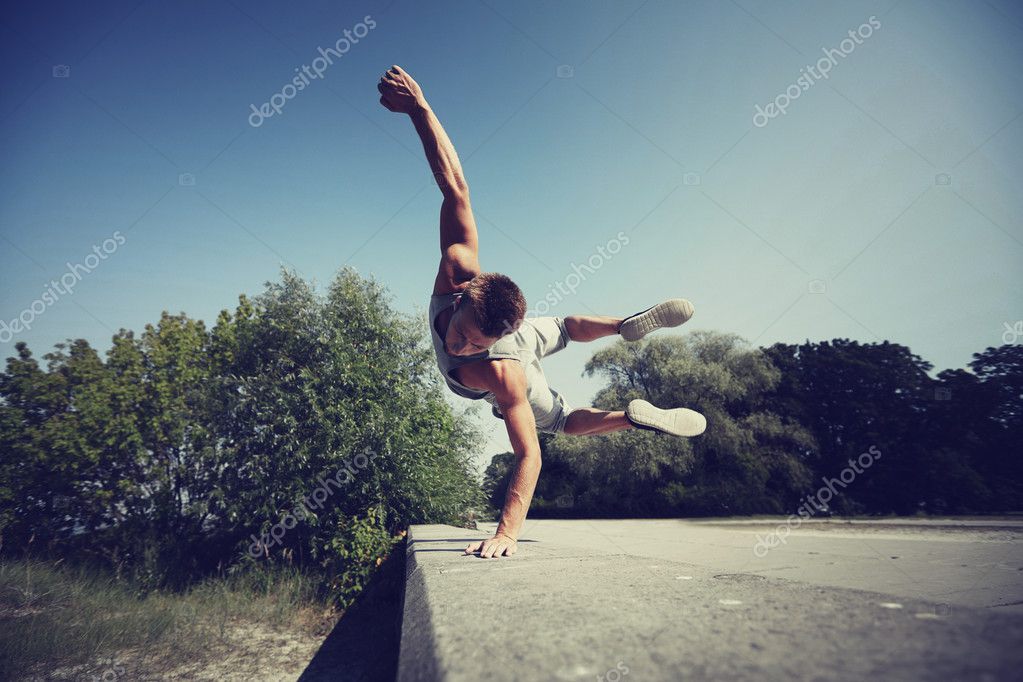 Sporty young man jumping in summer park Stock Photo by ©Syda ...