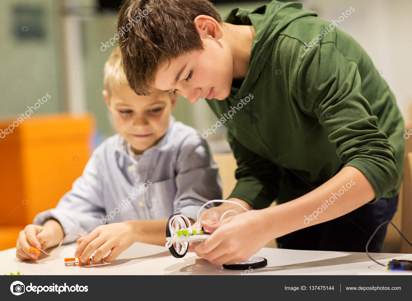 Happy children building robots at robotics school Stock Photo by ©Syda ...