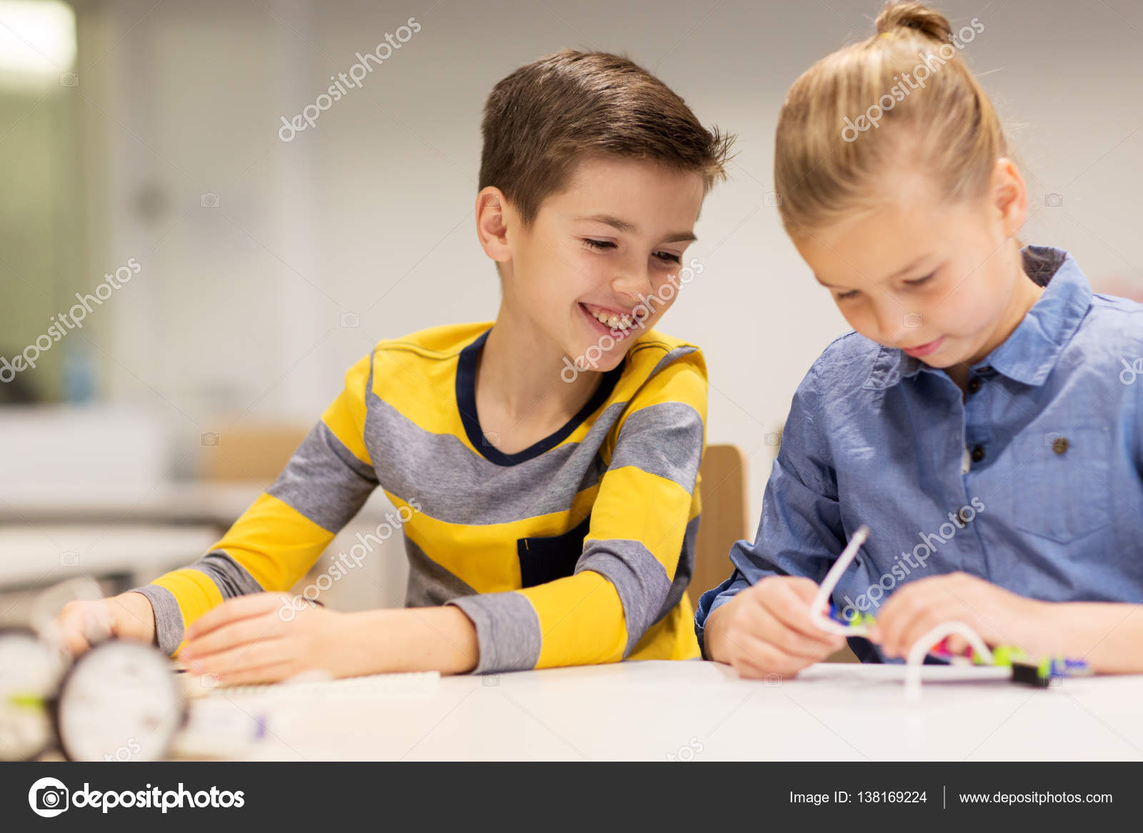 Happy children building robots at robotics school Stock Photo by ©Syda ...